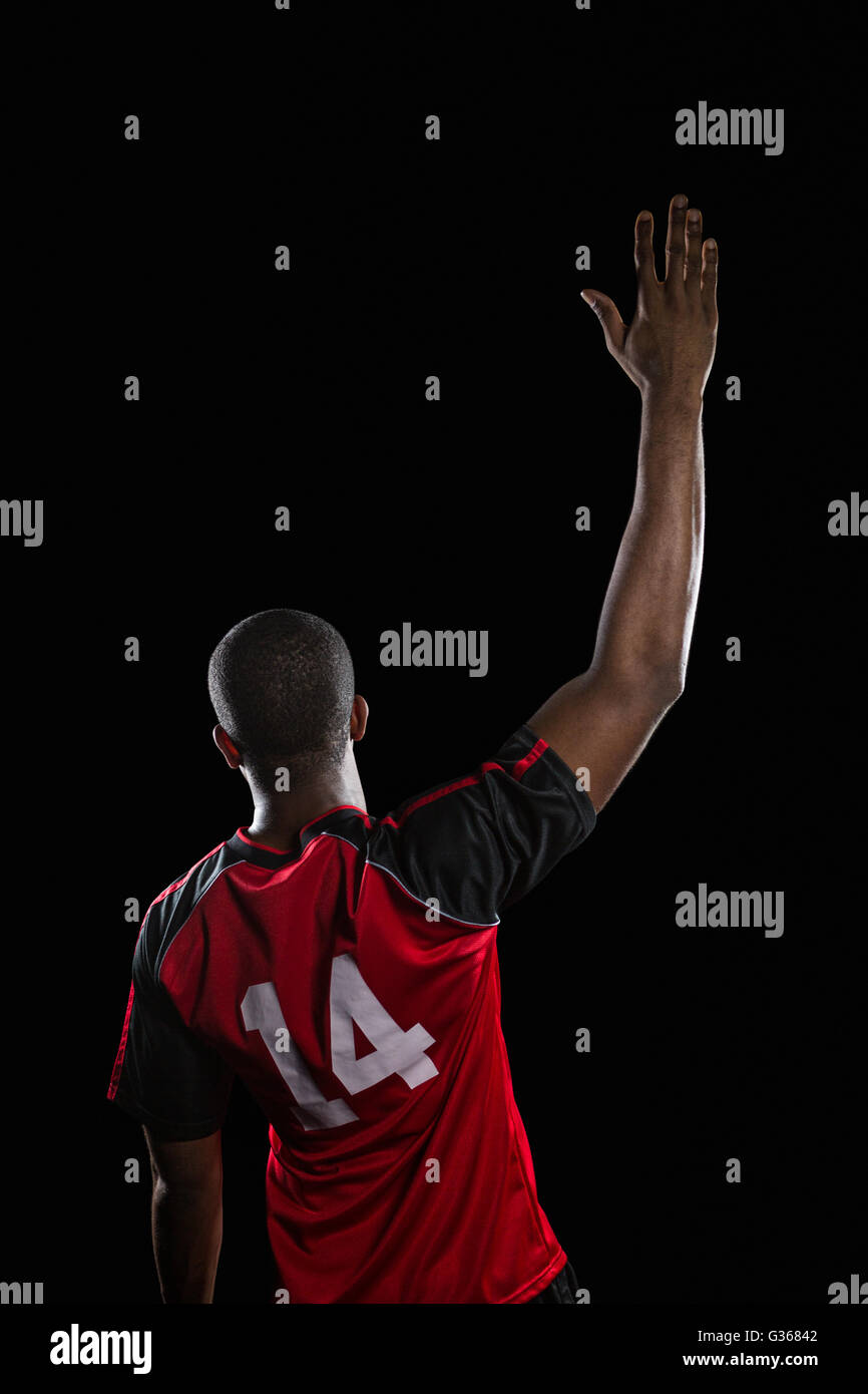 Rear view of sportsman posing while playing volleyball Stock Photo - Alamy
