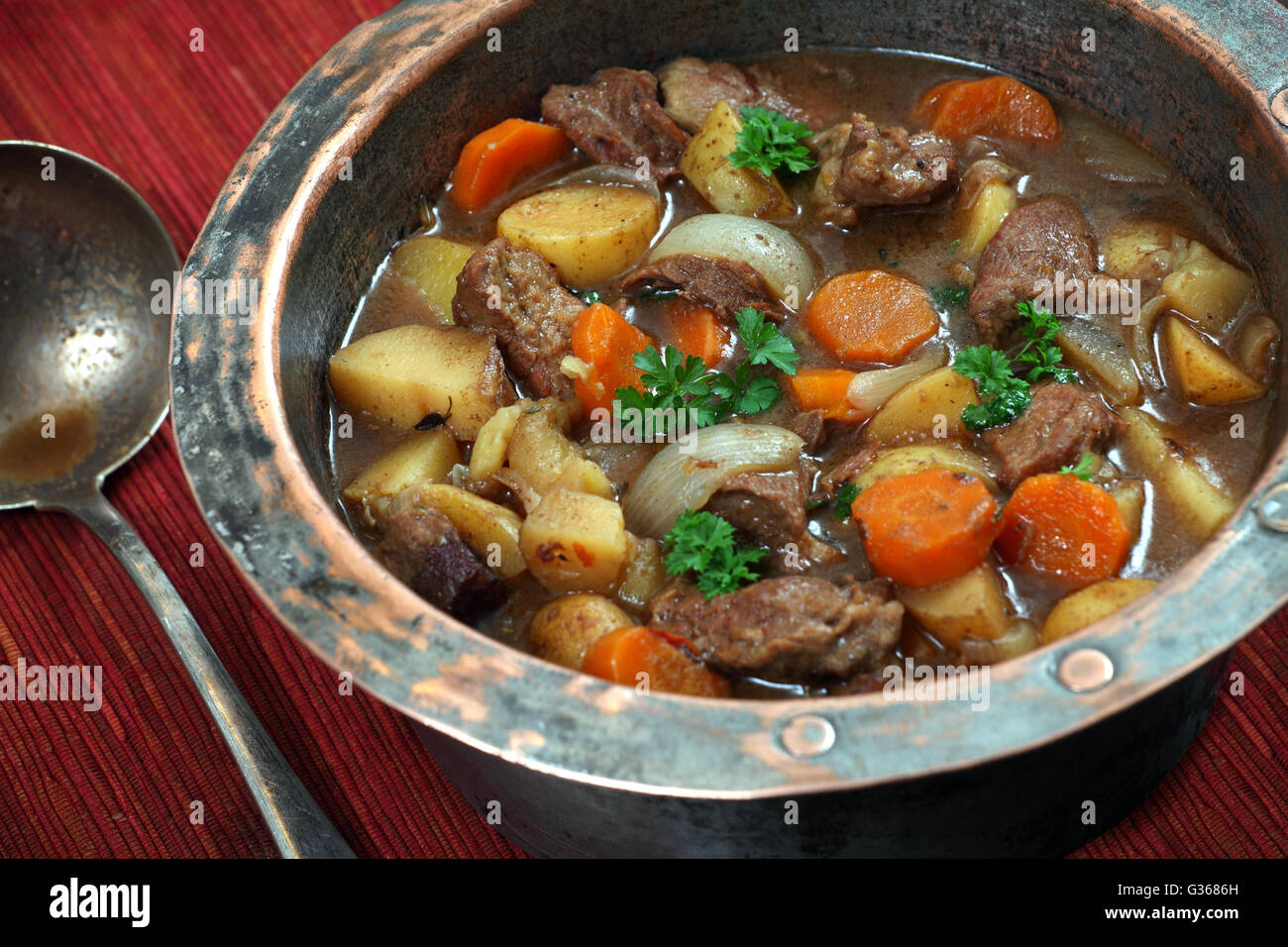 Photo of of Irish Stew or Guinness Stew made in an old well worn copper ...