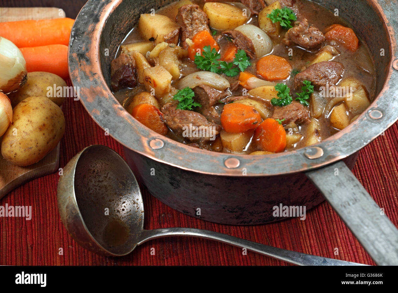 Photo of of Irish Stew or Guinness Stew made in an old well worn copper ...