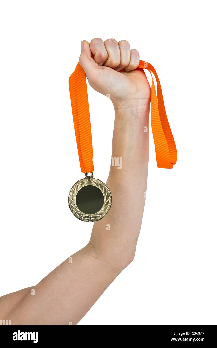 Athlete holding gold medal after victory Stock Photo - Alamy