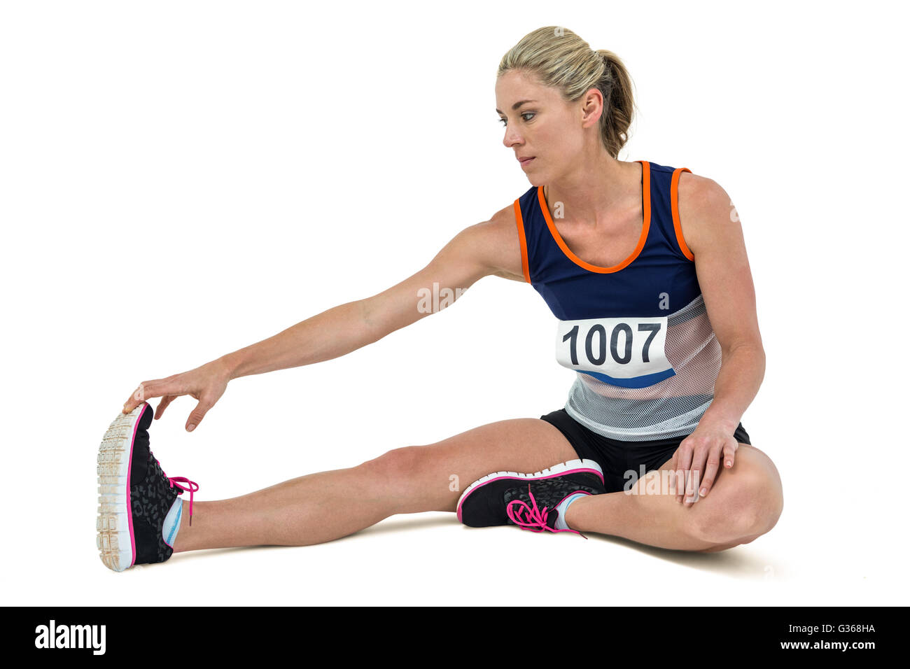 Athletic woman stretching her hamstring Stock Photo - Alamy