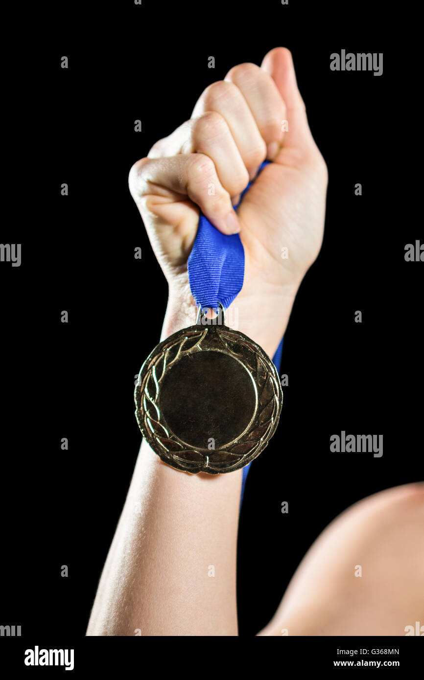 Athlete holding gold medal after victory Stock Photo - Alamy