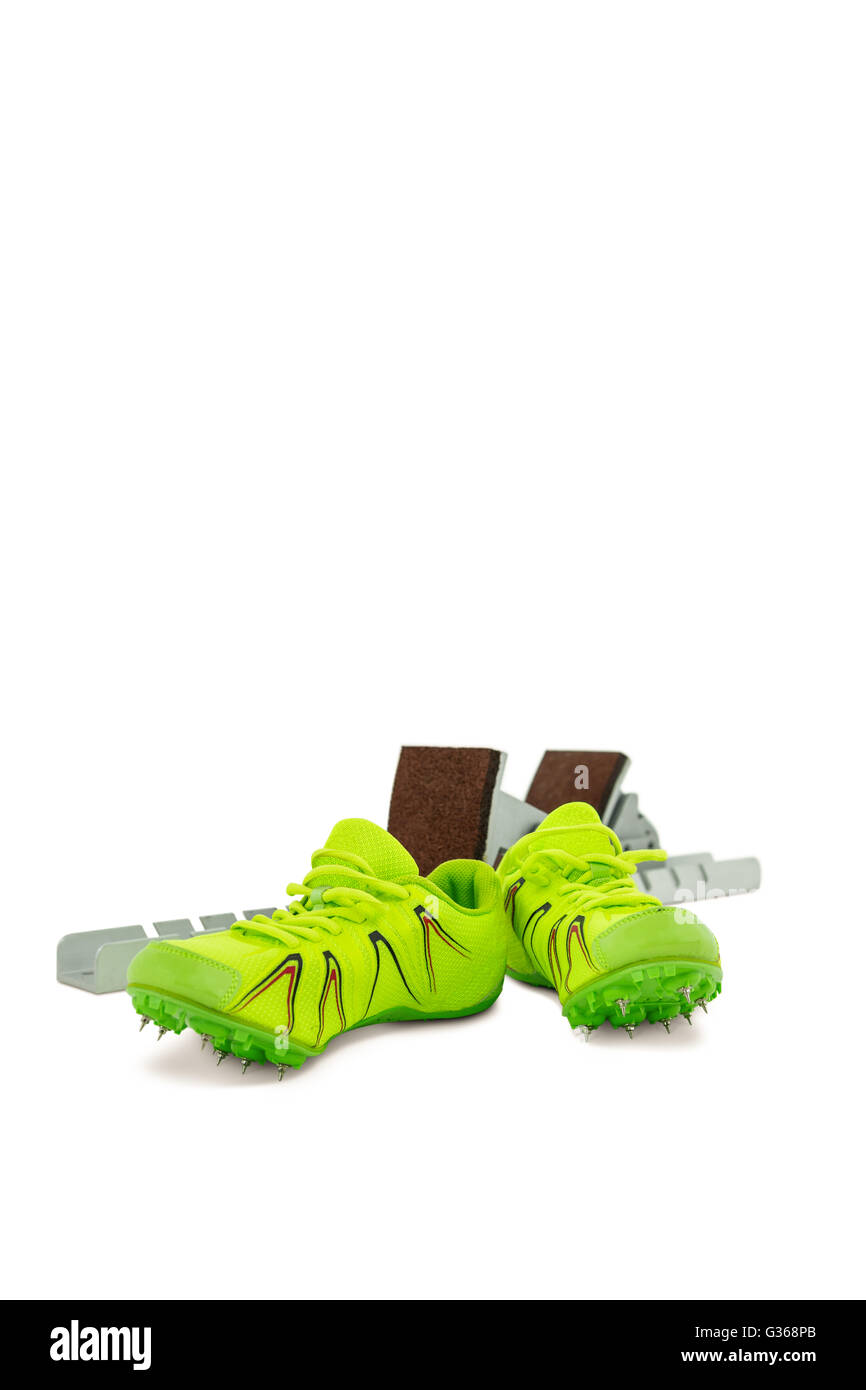Trainer shoes and starting block on white background Stock Photo - Alamy