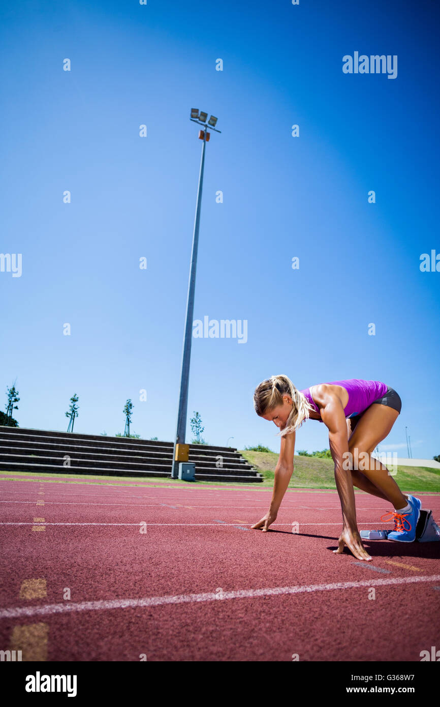 Female athlete ready to run on running track Stock Photo - Alamy