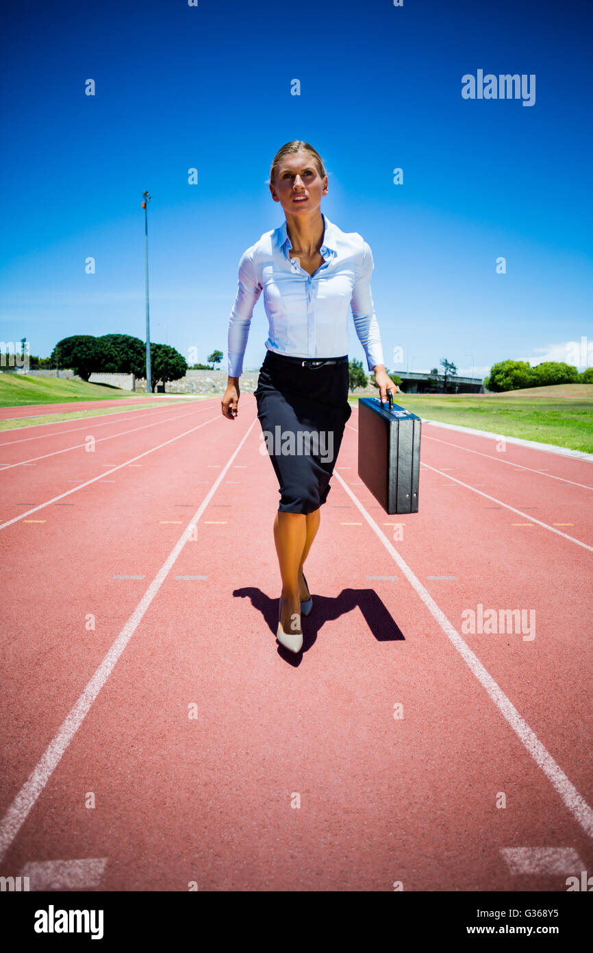 Businesswoman running on a running track Stock Photo - Alamy