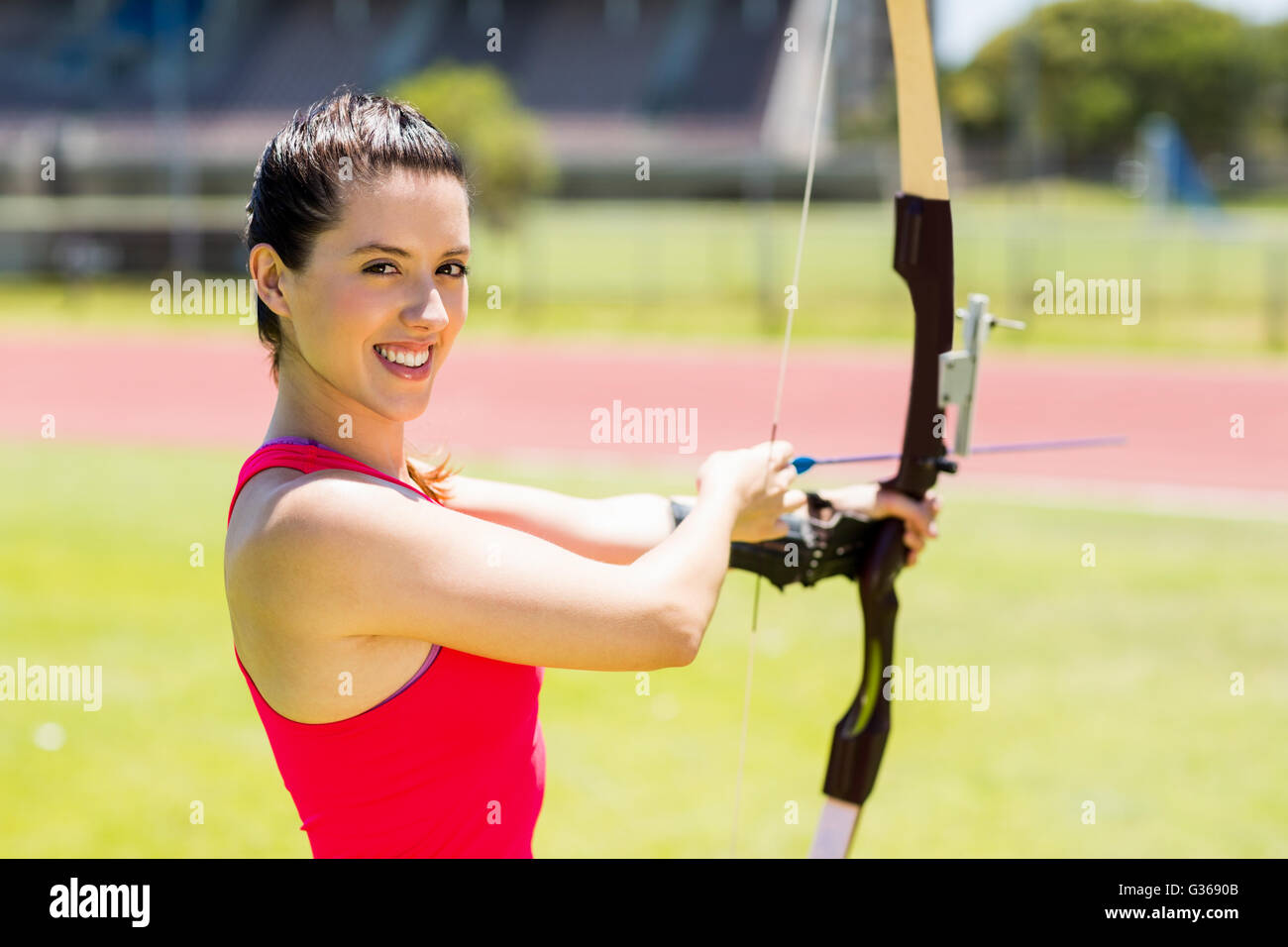 Female athlete practicing archery Stock Photo - Alamy