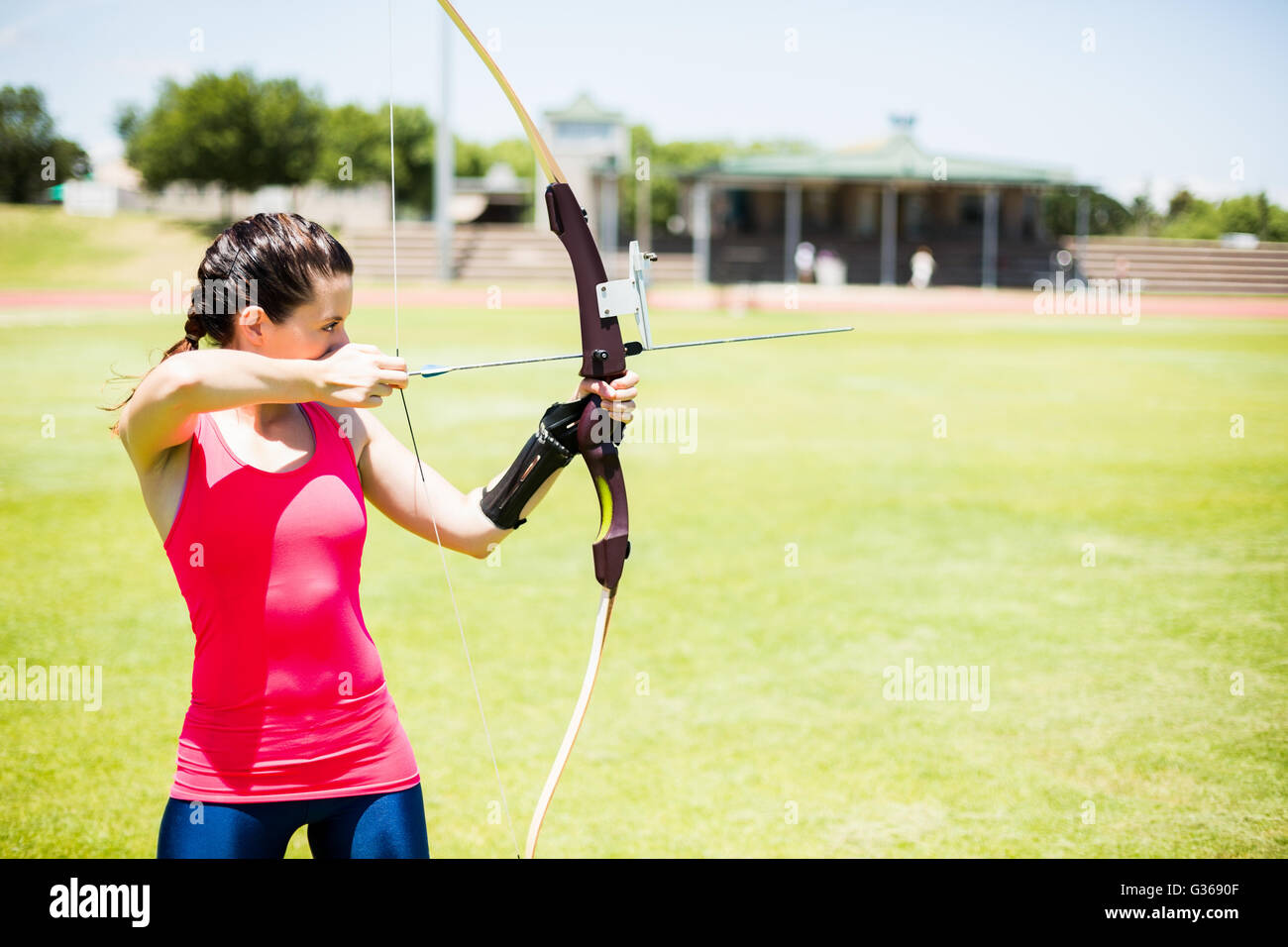 Female athlete practicing archery Stock Photo - Alamy