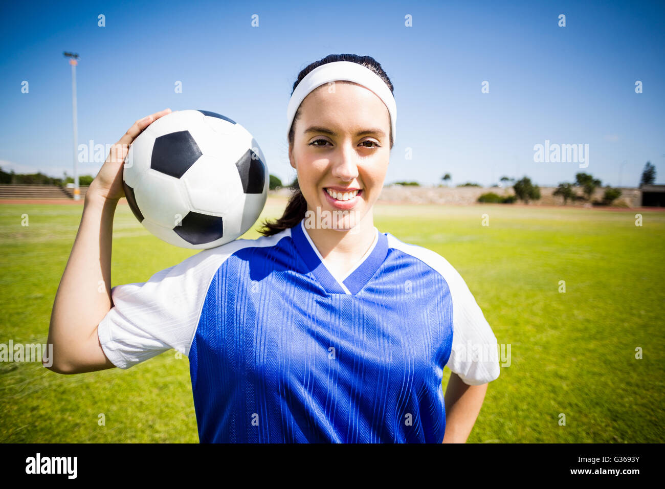 Happy soccer player standing with a ball Stock Photo - Alamy