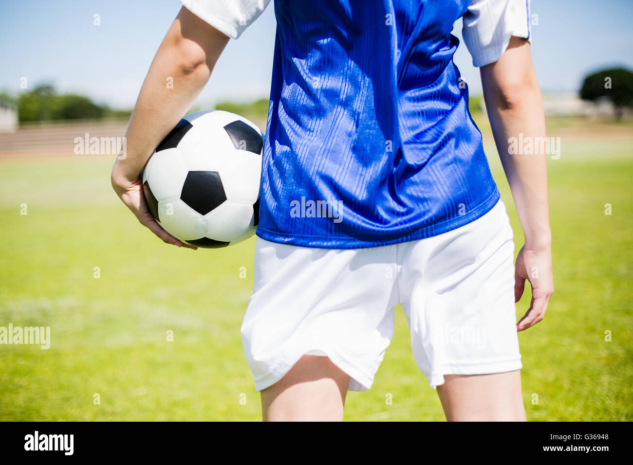 Mid-section of soccer player standing with a ball Stock Photo - Alamy