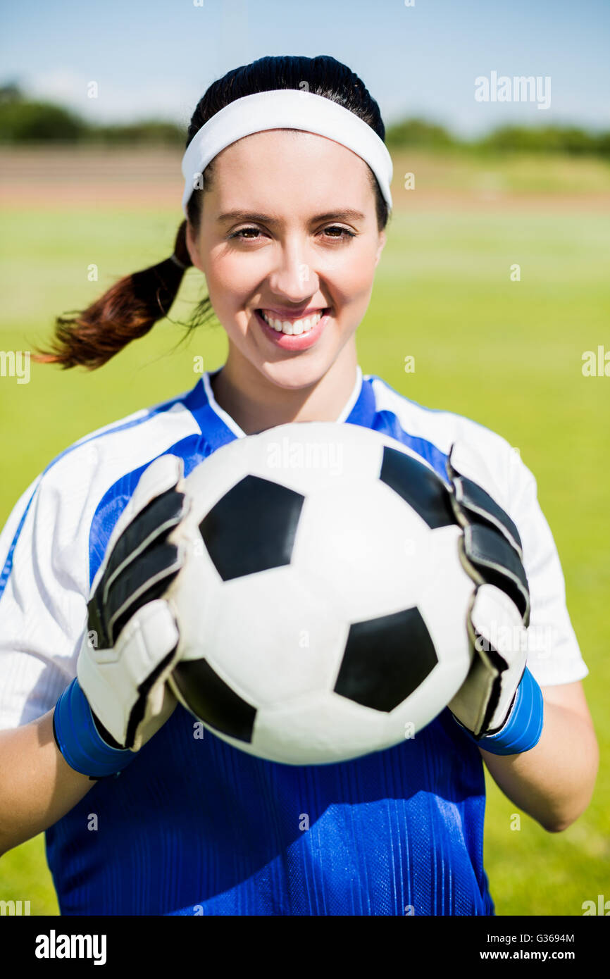 Happy soccer player standing with a ball Stock Photo - Alamy