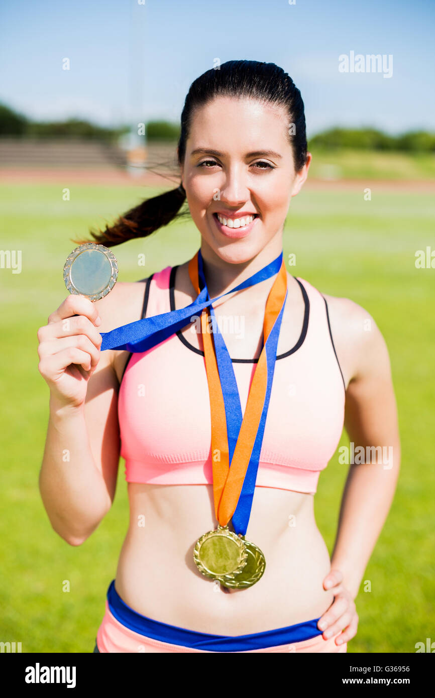 Portrait of female athlete showing her gold medals Stock Photo - Alamy