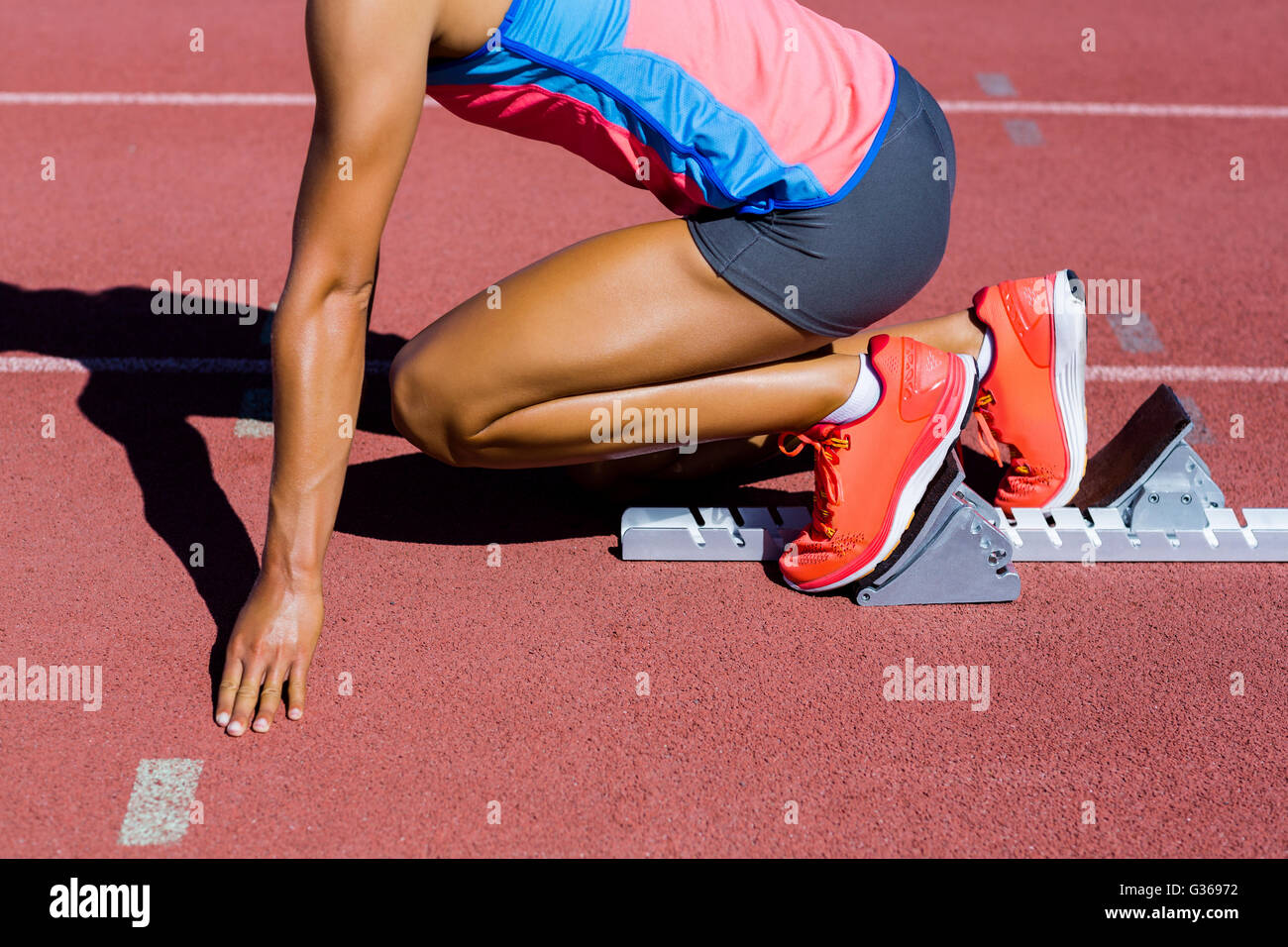 Female athlete ready to run on running track Stock Photo - Alamy