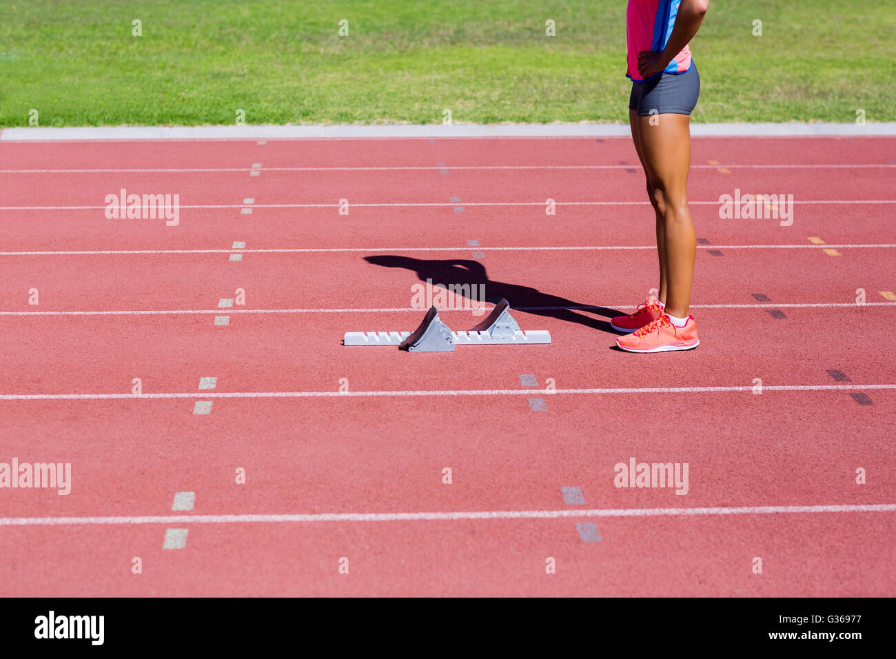 Female athlete ready to run on running track Stock Photo - Alamy