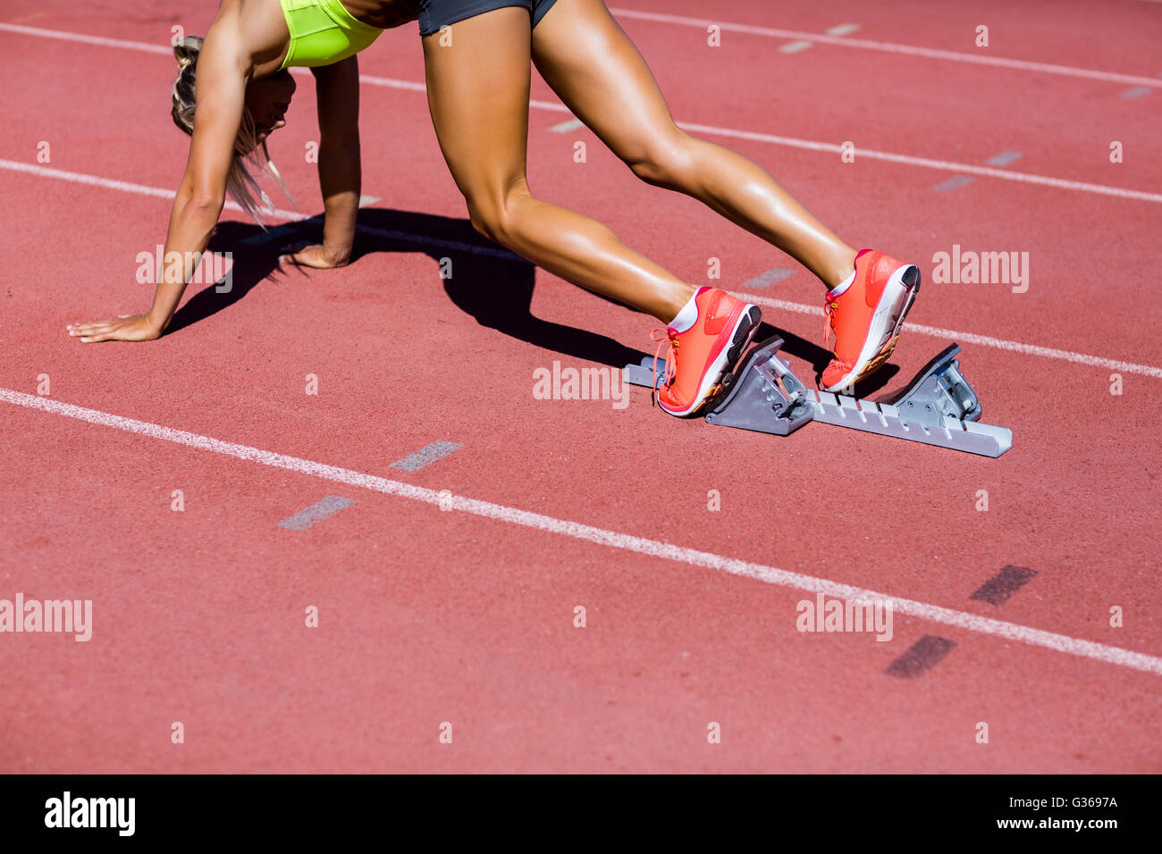 Female athlete ready to run on running track Stock Photo - Alamy