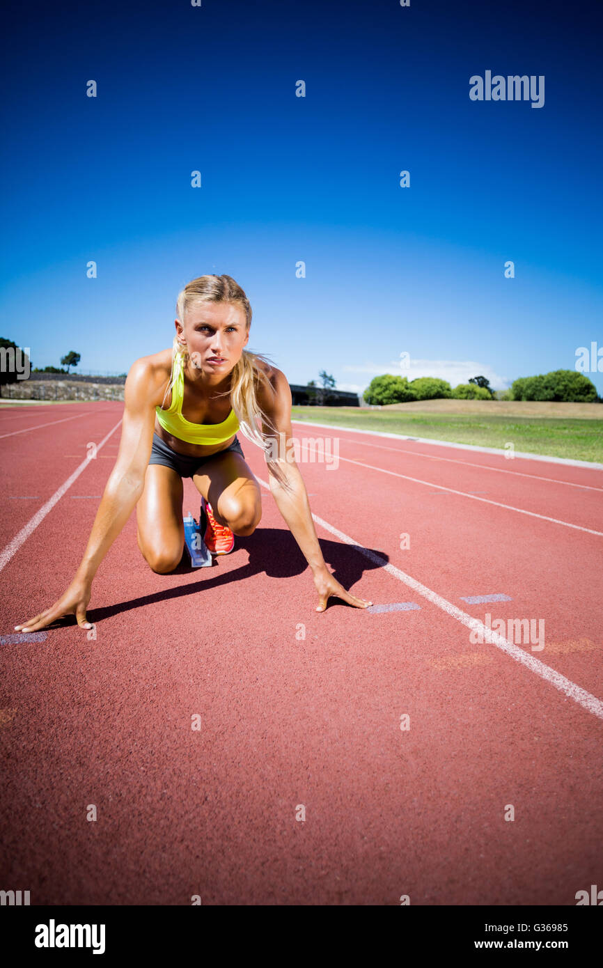 Female athlete ready to run on running track Stock Photo - Alamy