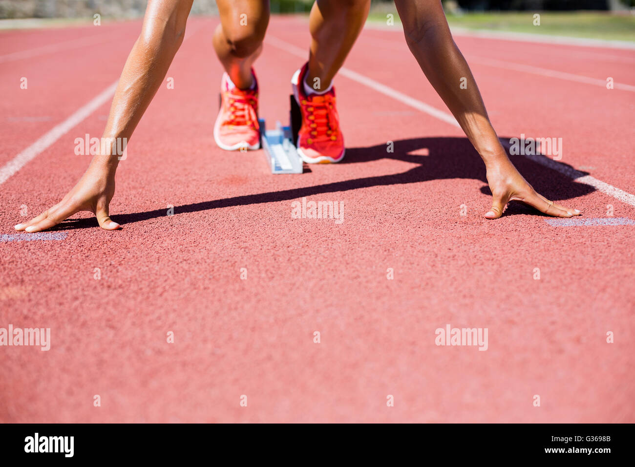 Female athlete ready to run on running track Stock Photo - Alamy