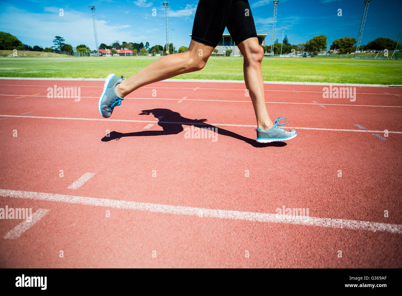 Female athlete running on the running track Stock Photo - Alamy