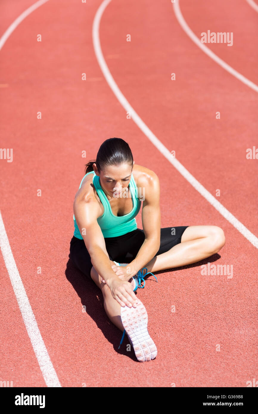Female athlete stretching her hamstring Stock Photo - Alamy