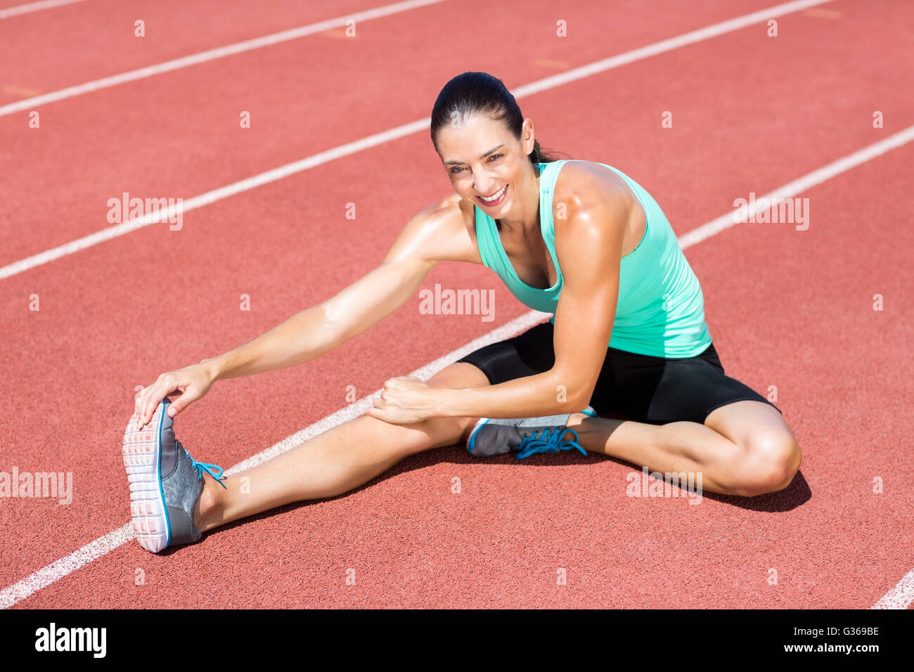 Portrait of female athlete stretching her hamstring Stock Photo - Alamy
