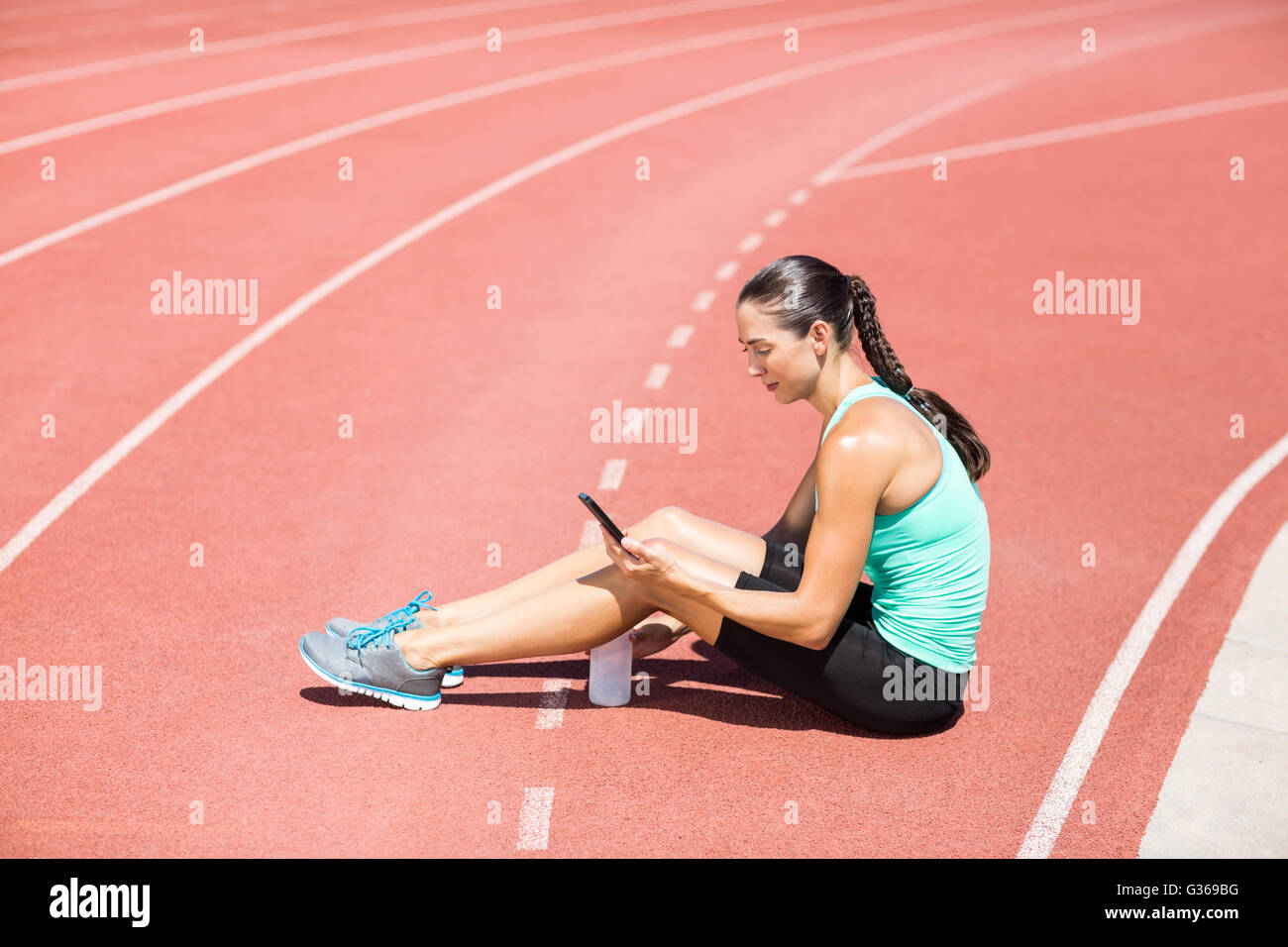 Female athlete using mobile phone Stock Photo - Alamy