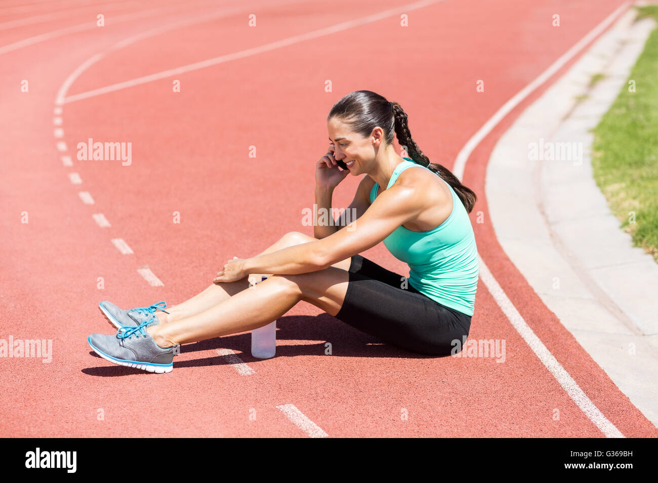 Woman runner talking on phone hi-res stock photography and images - Alamy