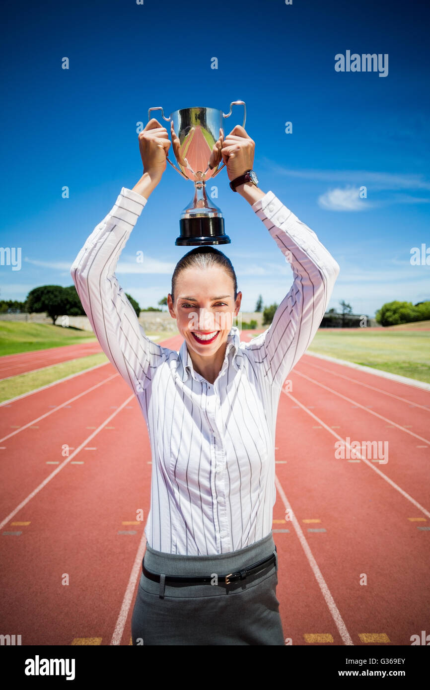 Victory holding trophy hi-res stock photography and images - Alamy