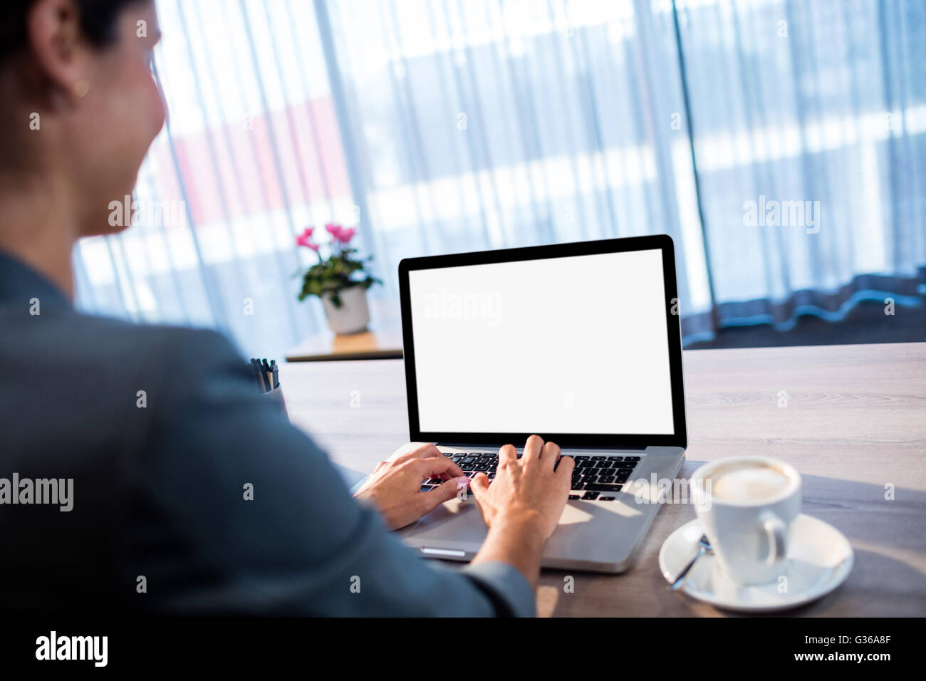 Businesswoman using wireless computer workplace hi-res stock ...