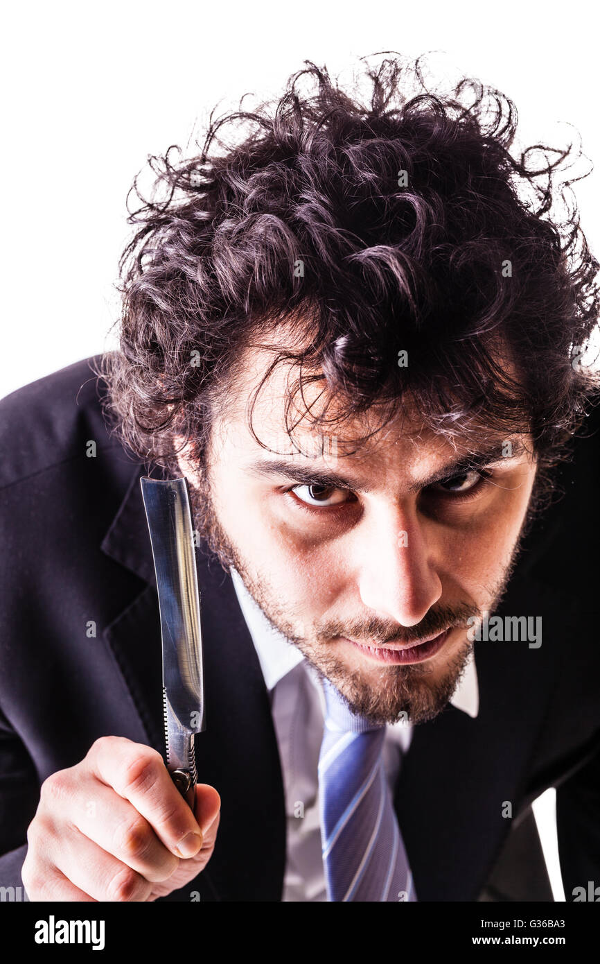a young and handsome businessman holding a cut-throat razor isolated ...