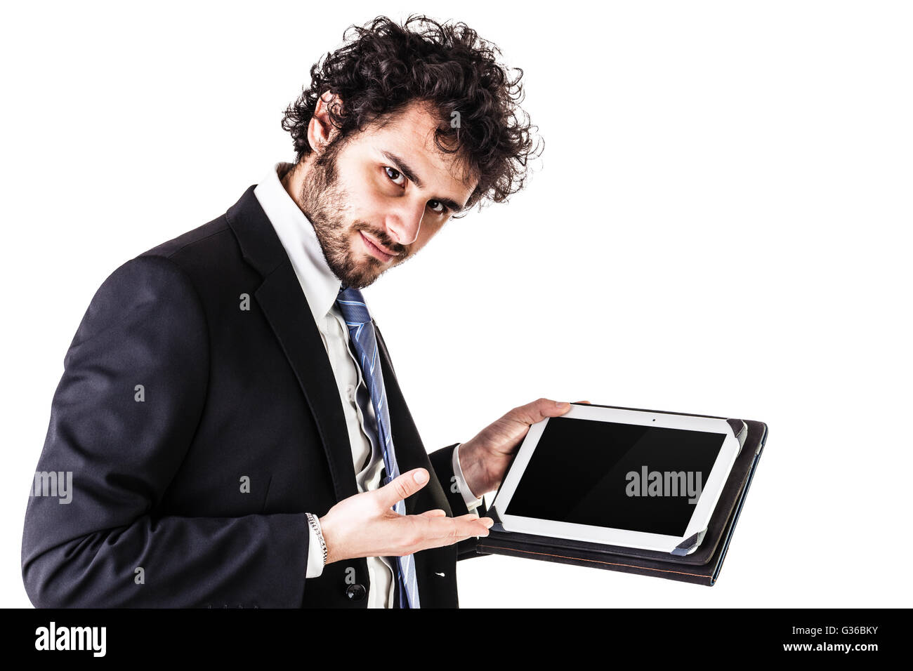 a young and handsome businessman holding a tablet isolated over a white ...