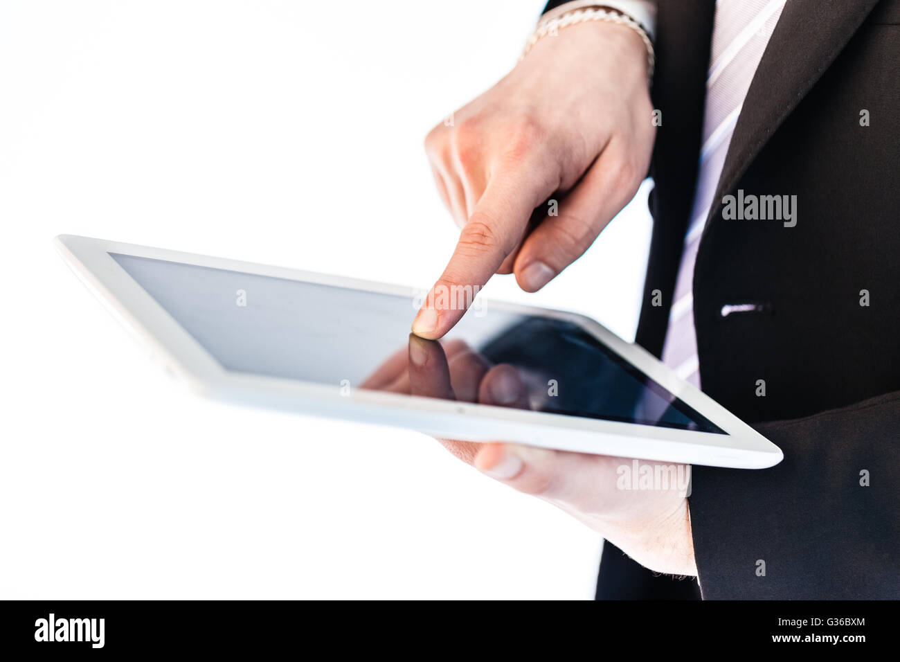a young and handsome businessman holding a tablet isolated over a white ...