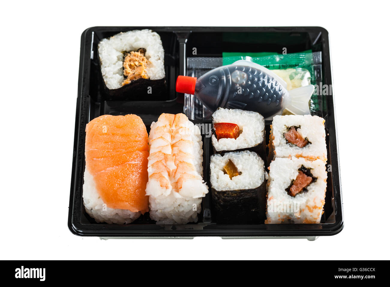 a sushi box or bento box with assorted sushi pieces isolated over a ...