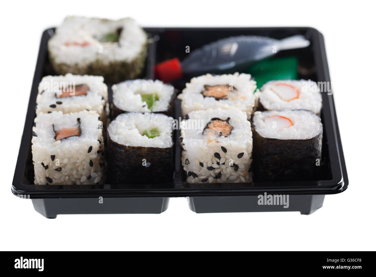a sushi box or bento box with assorted sushi pieces isolated over a ...