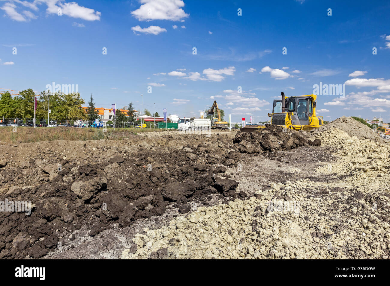 Earthmover with caterpillar is moving earth outdoors Stock Photo - Alamy
