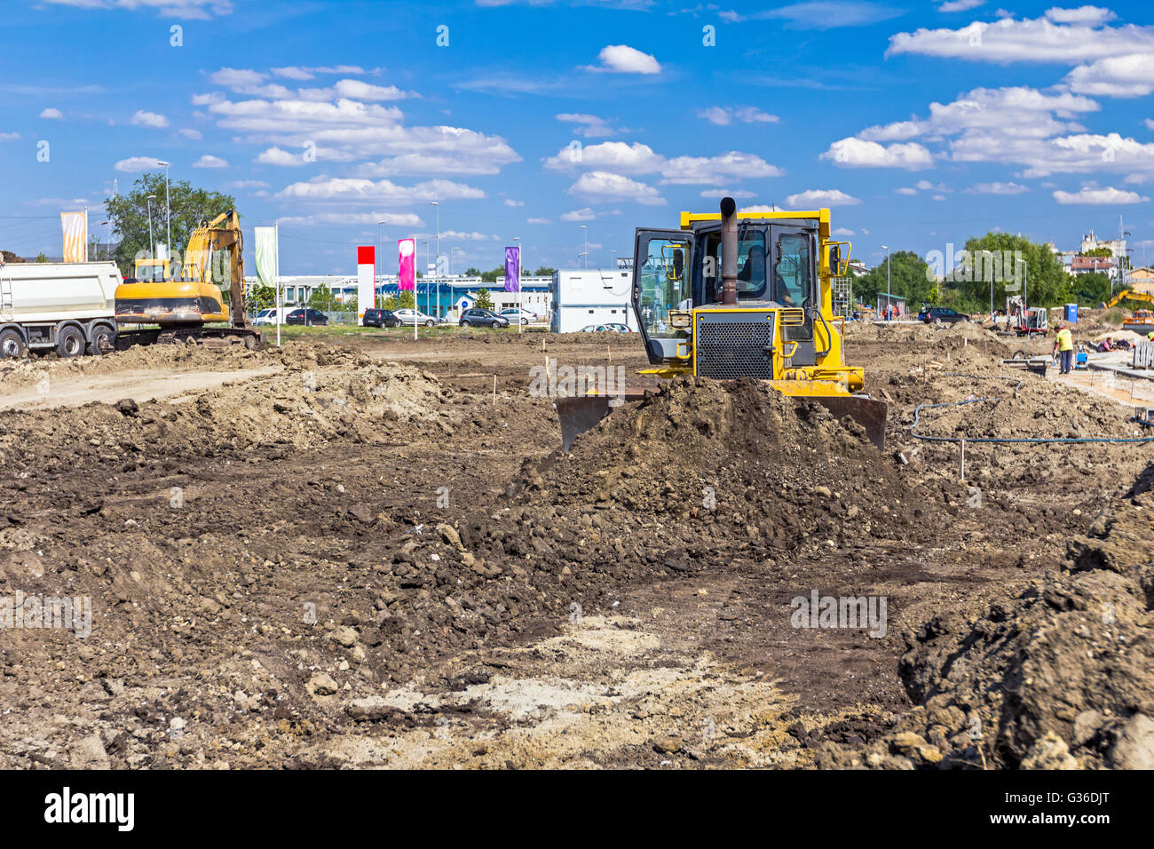 Earthmover with caterpillar is moving earth outdoors Stock Photo - Alamy
