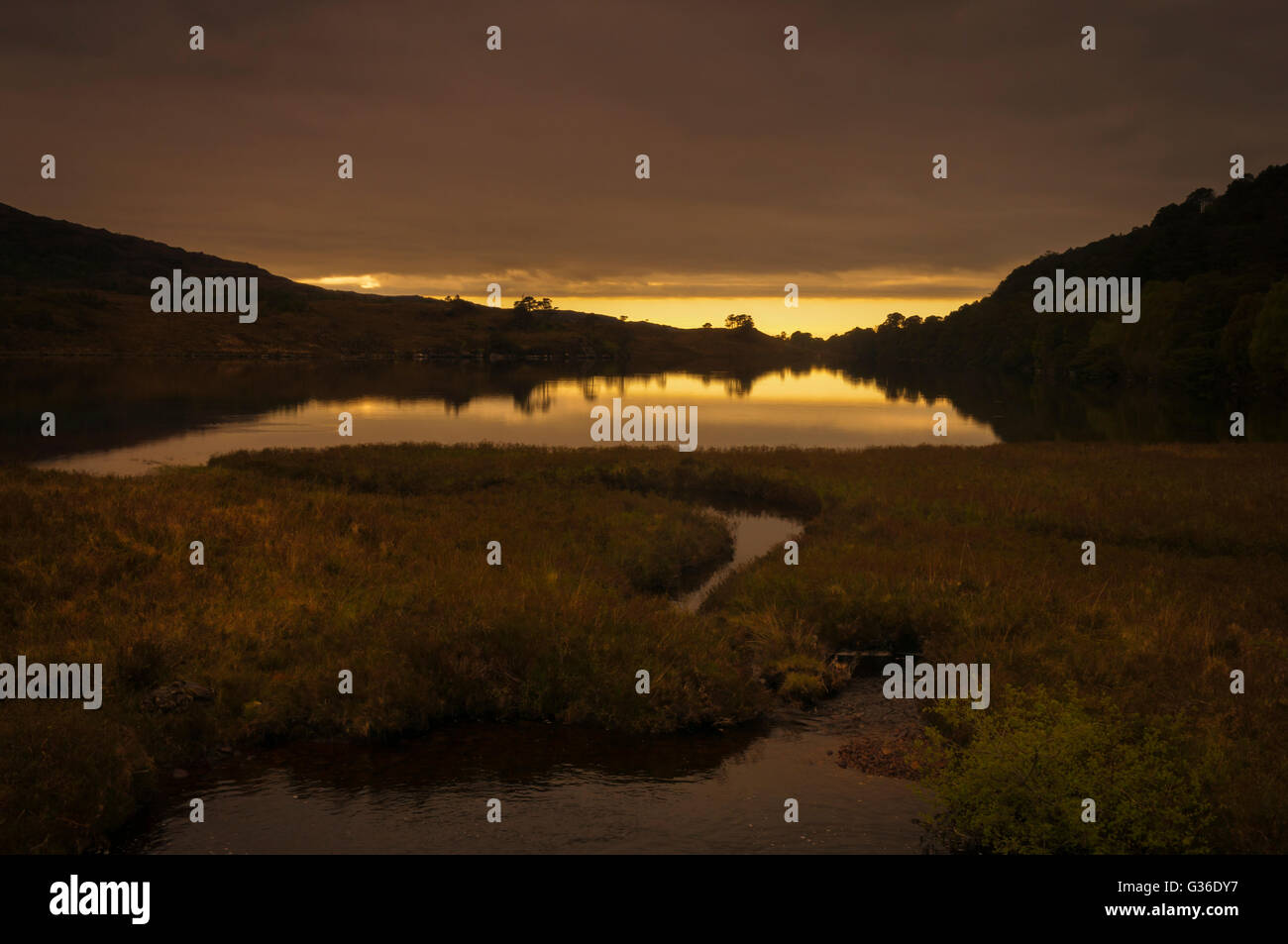 A silhouette photograph of a sunset over Loch Dughaill in the Scottish ...
