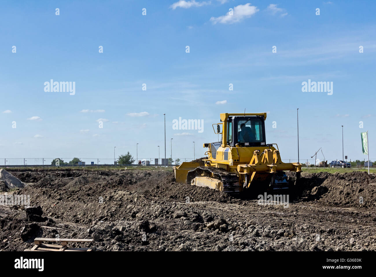 Earthmover with caterpillar is moving earth outdoors Stock Photo - Alamy