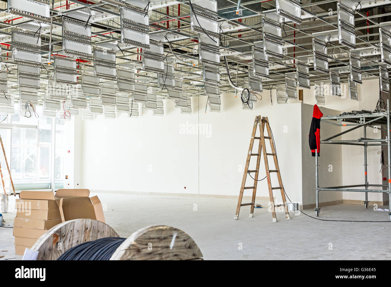 Workers are used wooden ladder to complete suspended office ceiling at ...