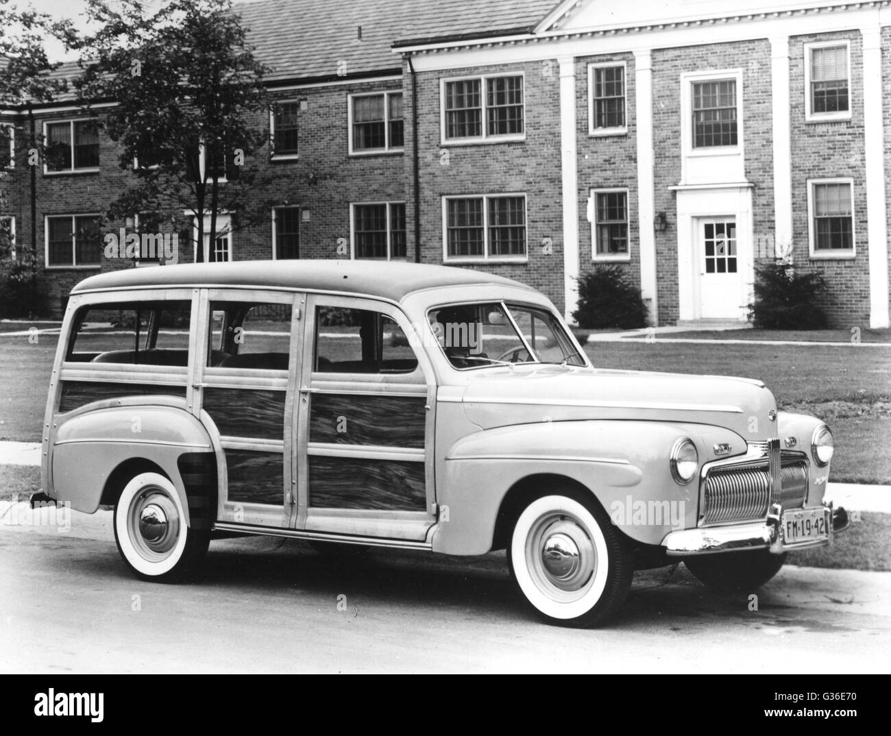 Publicity photo showing a 1942 model Ford station wagon with wood sides ...