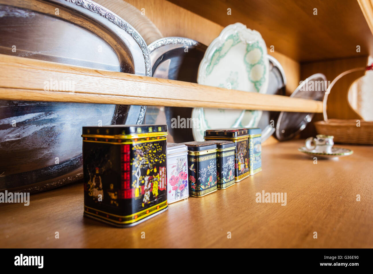 some chinese tea tin boxes on the shelf of a plate rack Stock Photo - Alamy