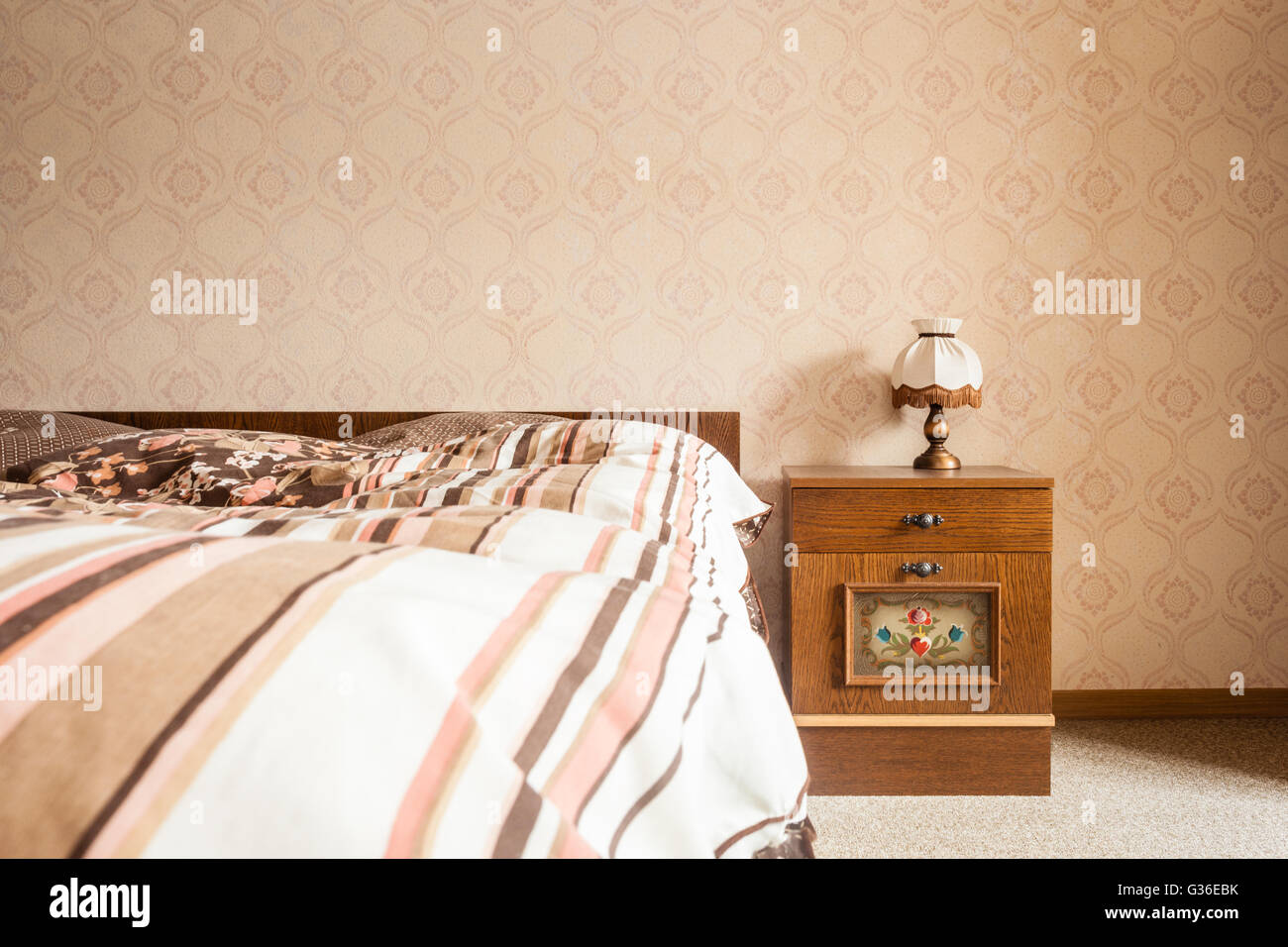 a retro styled bed and bedside table in a vintage room Stock Photo - Alamy