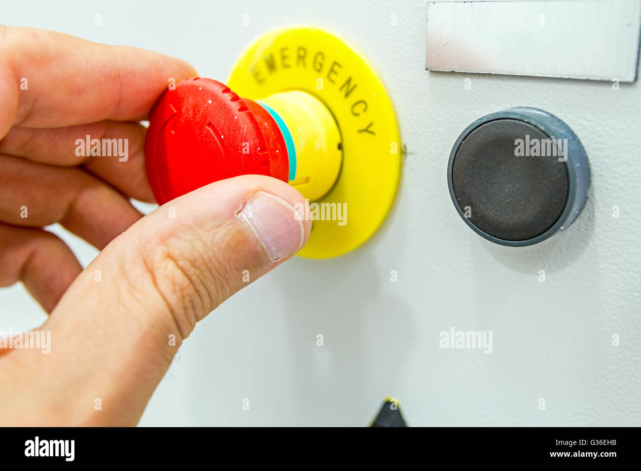 Hand is operating a heavy duty switch on electrical cabinet providing ...