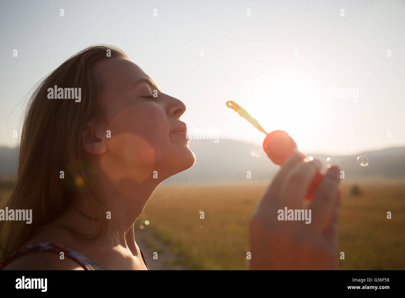 Bubble blower woman Stock Photo - Alamy