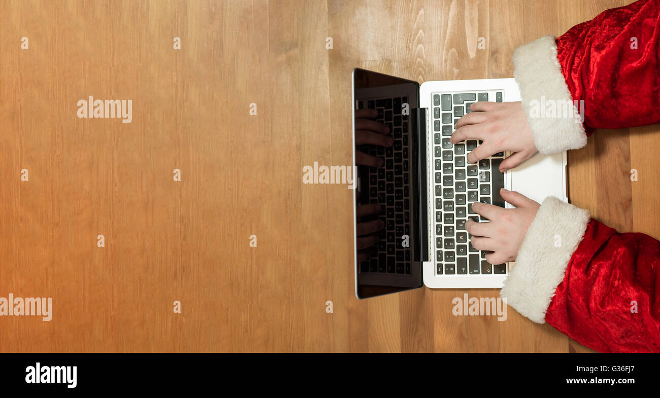 Santa Claus typing on an laptop Stock Photo - Alamy
