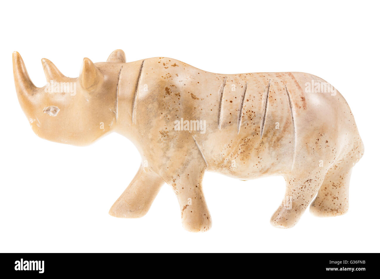 a stone rhino figurine isolated over a white background Stock Photo - Alamy