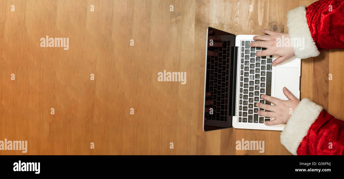 Santa Claus typing on an laptop Stock Photo - Alamy