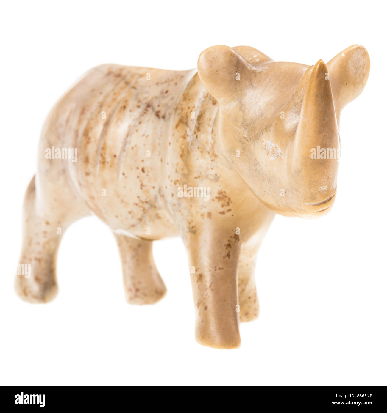 a stone rhino figurine isolated over a white background Stock Photo - Alamy