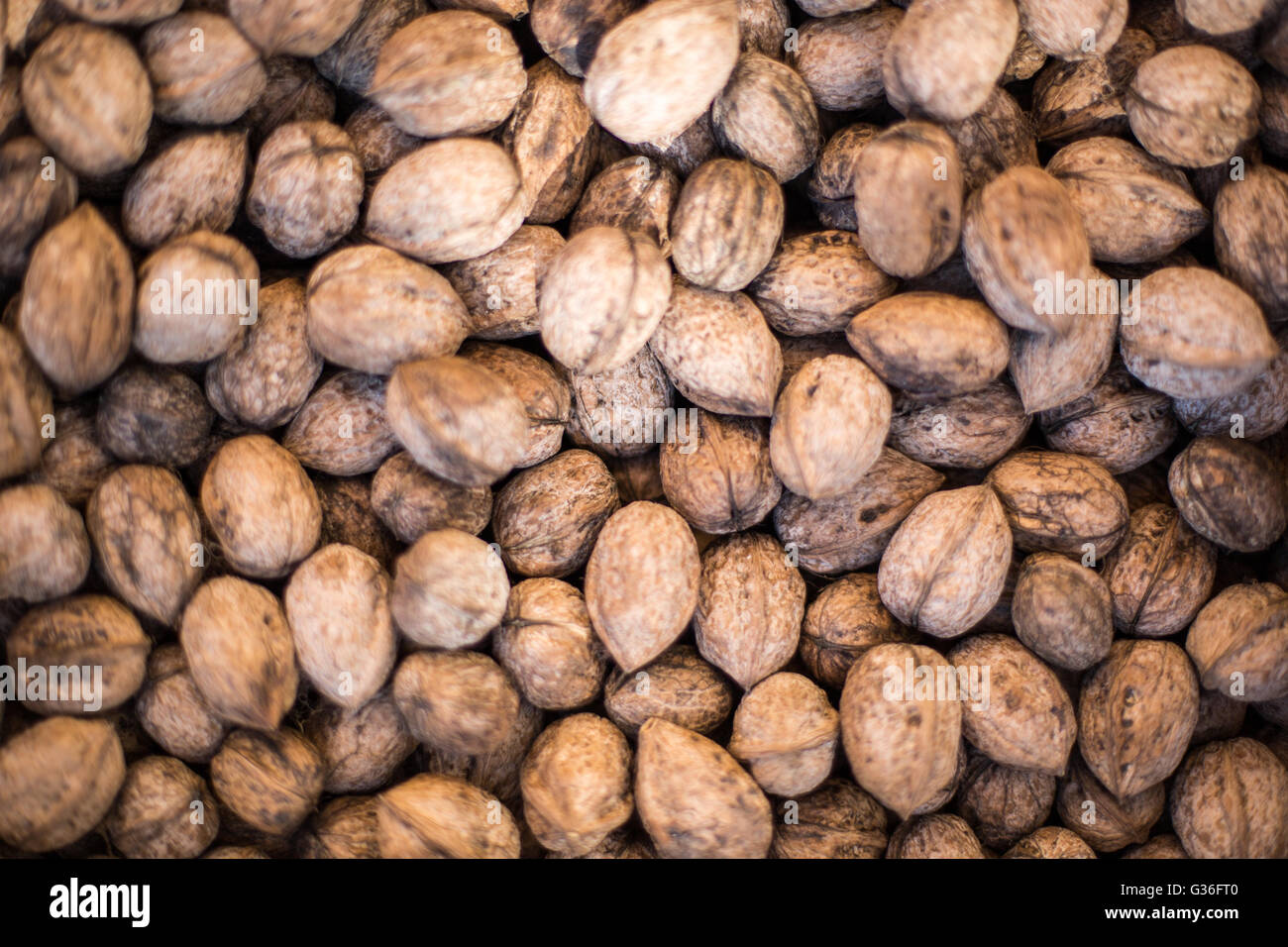 Walnut background, scattered pile of walnuts Stock Photo - Alamy