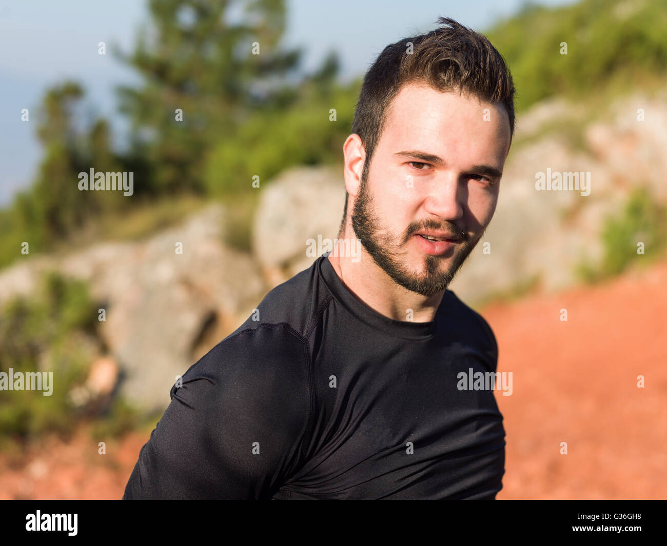 Athlete male runner running on mountain road. Running man jogging fast ...