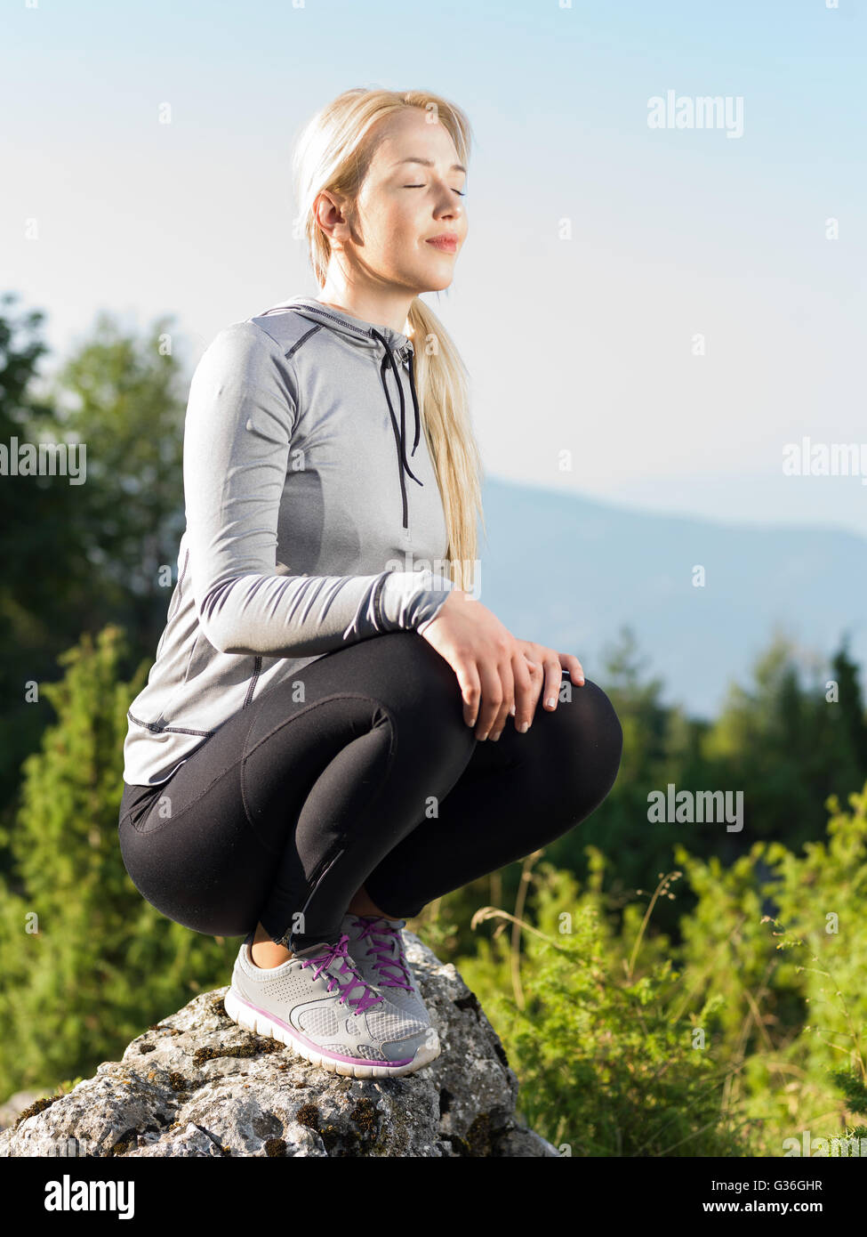 Athlete runner woman relaxing after running. Fitness girl resting after ...
