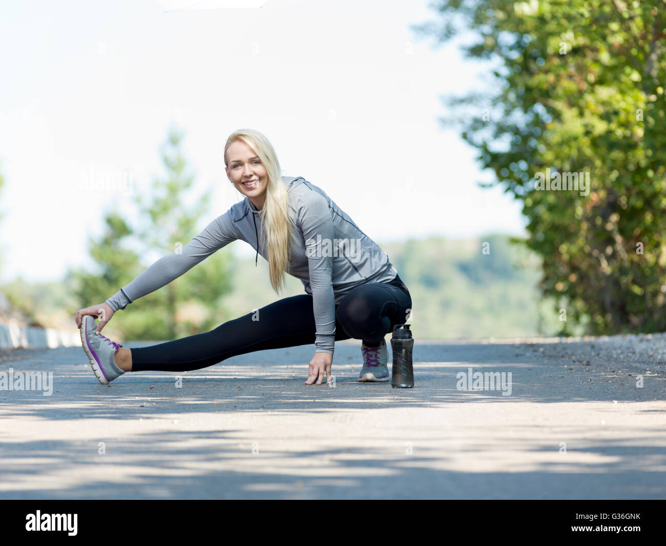 Fitness woman doing streching during outdoor cross training workout ...
